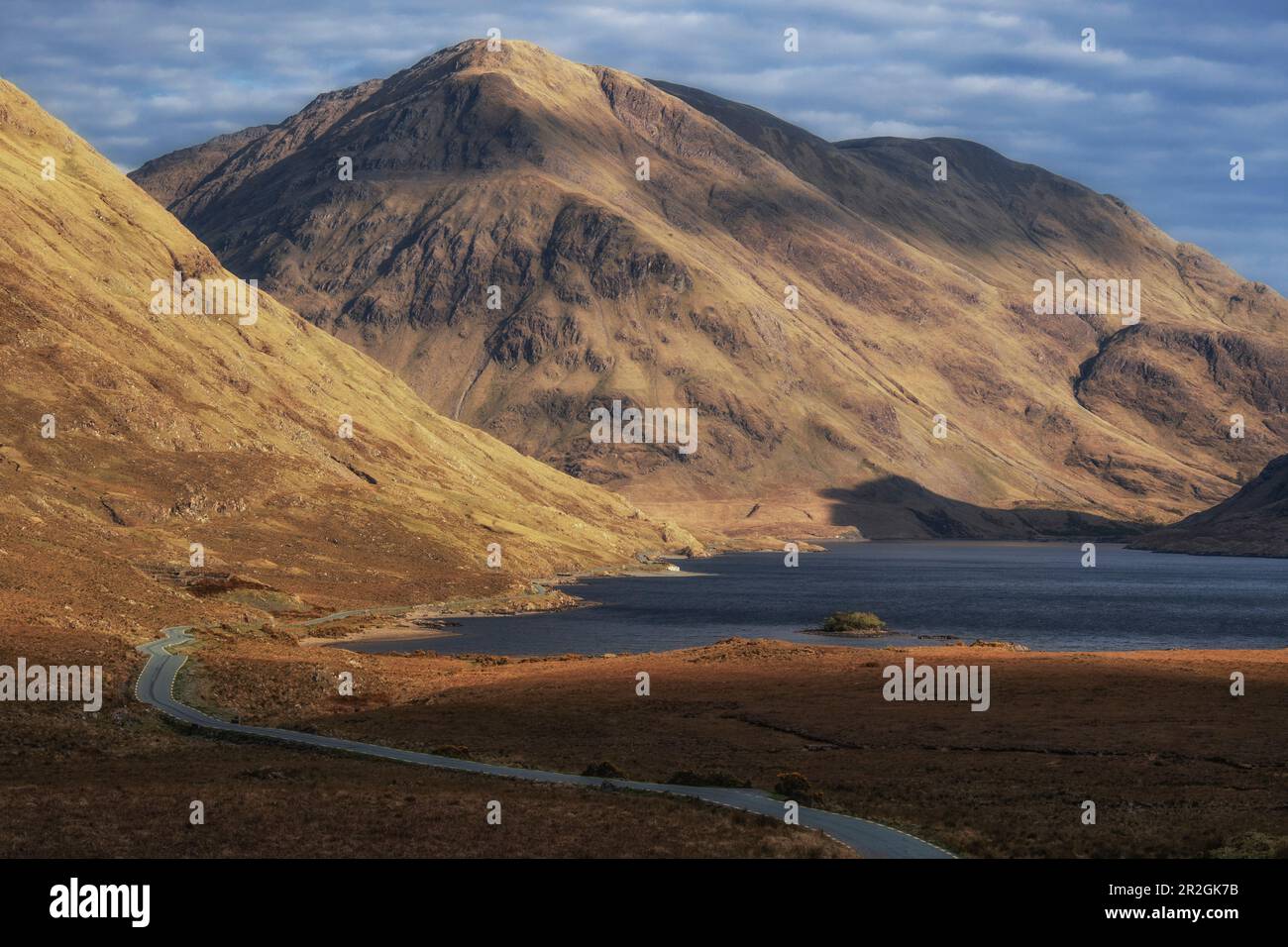 Road meanders past Doo Lough. mountains in the background. Clashcame ...