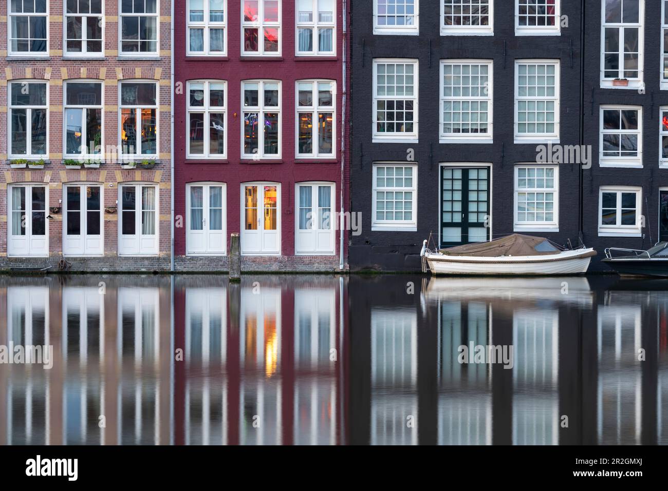 Typical Amsterdam houses with reflections in the Damrak Canal, Amsterdam, North Holland ...