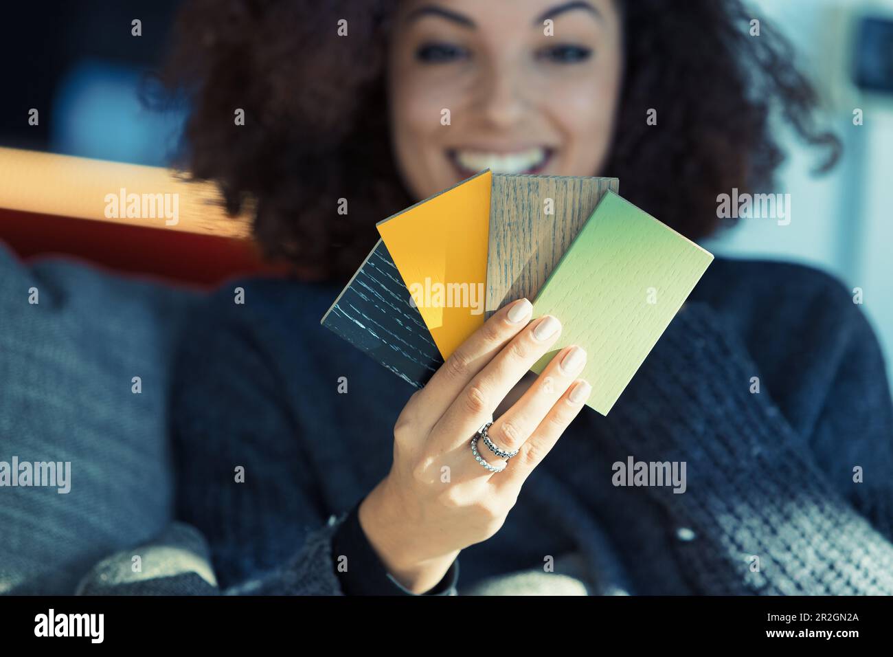 A beautiful ethnic-looking girl, engrossed in selecting colors from a ...