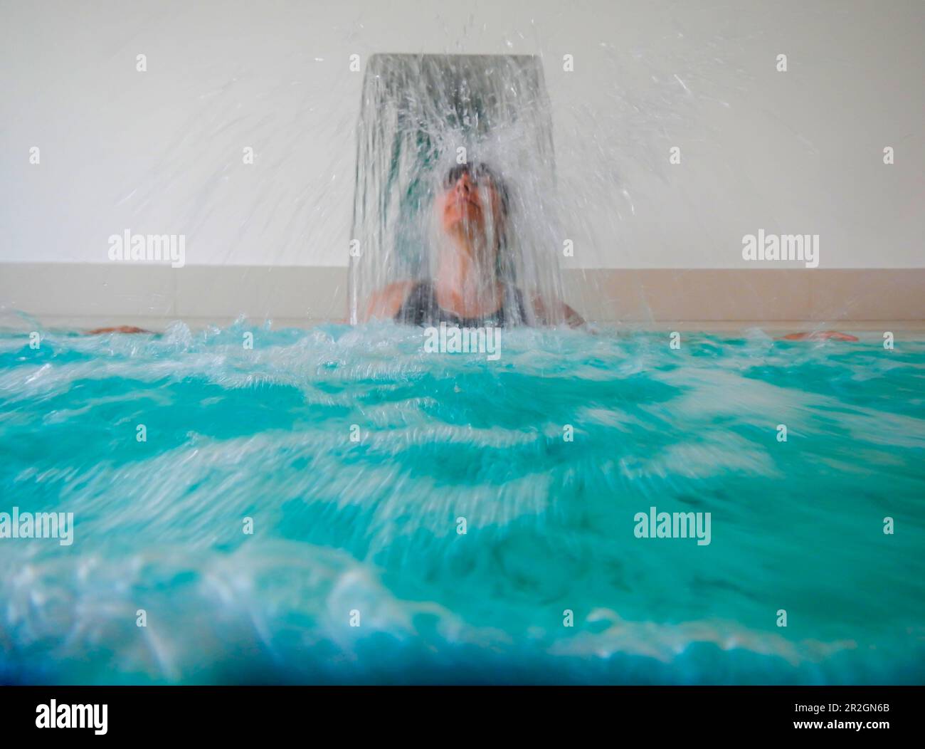 Woman in Hydro Massage Pool with Falling Water in Swimming Pool in ...