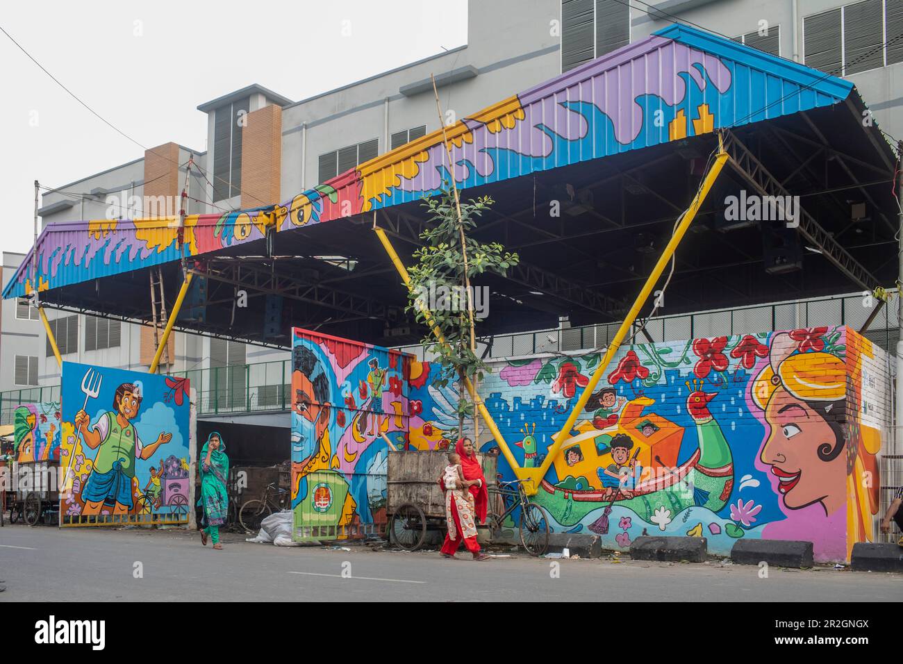 Dhaka, Bangladesh. 19th May, 2023. People walk past the graffiti in the ...