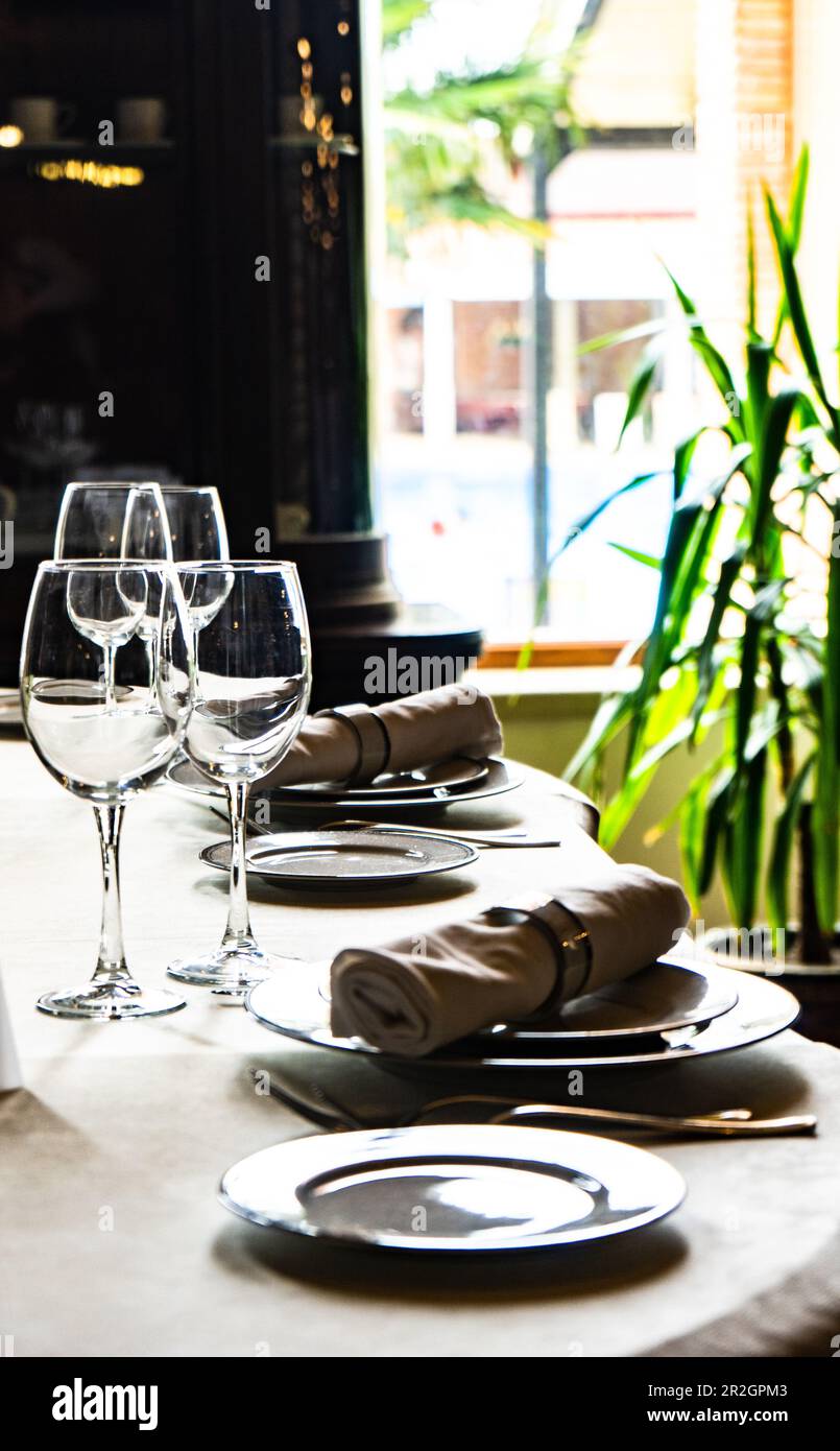 Vintage place setting for dinner in dark interior Stock Photo - Alamy