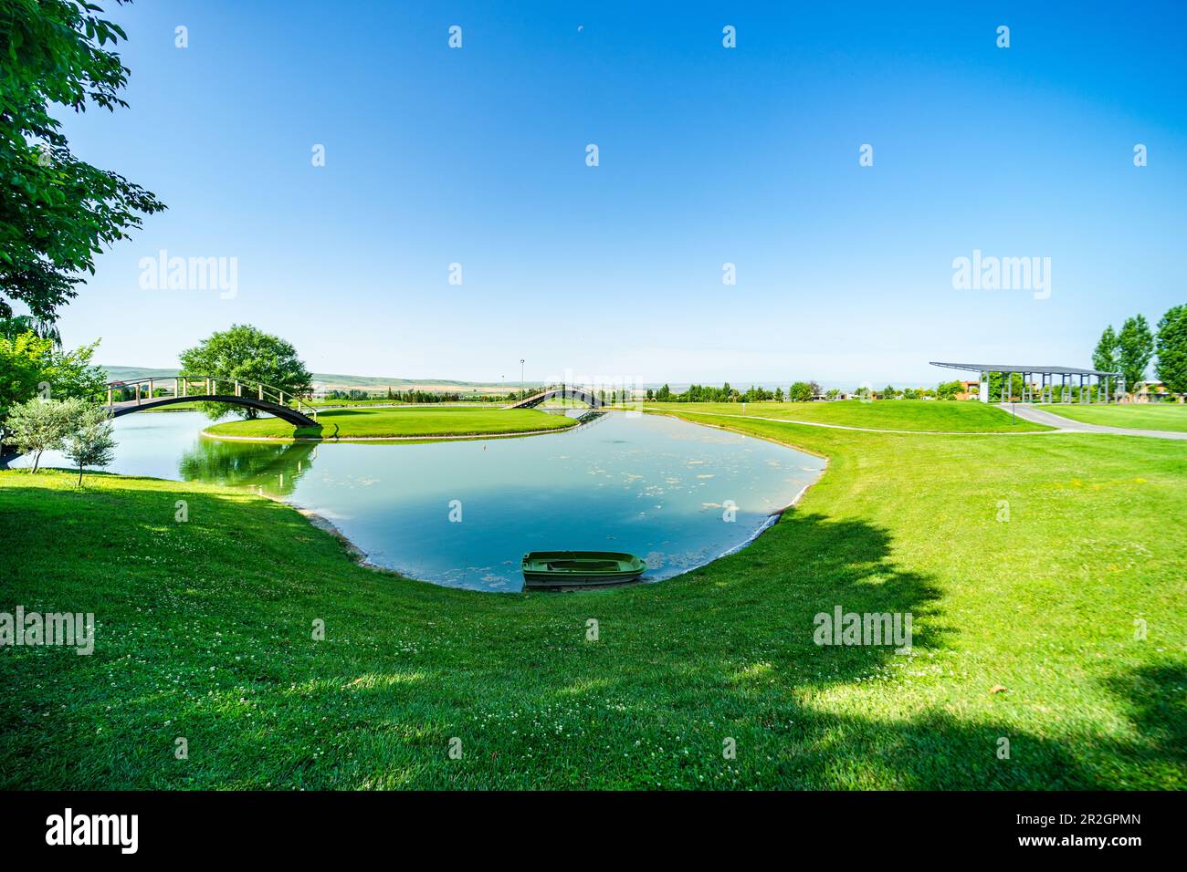 Pond with reflection in golf grassland Stock Photo - Alamy