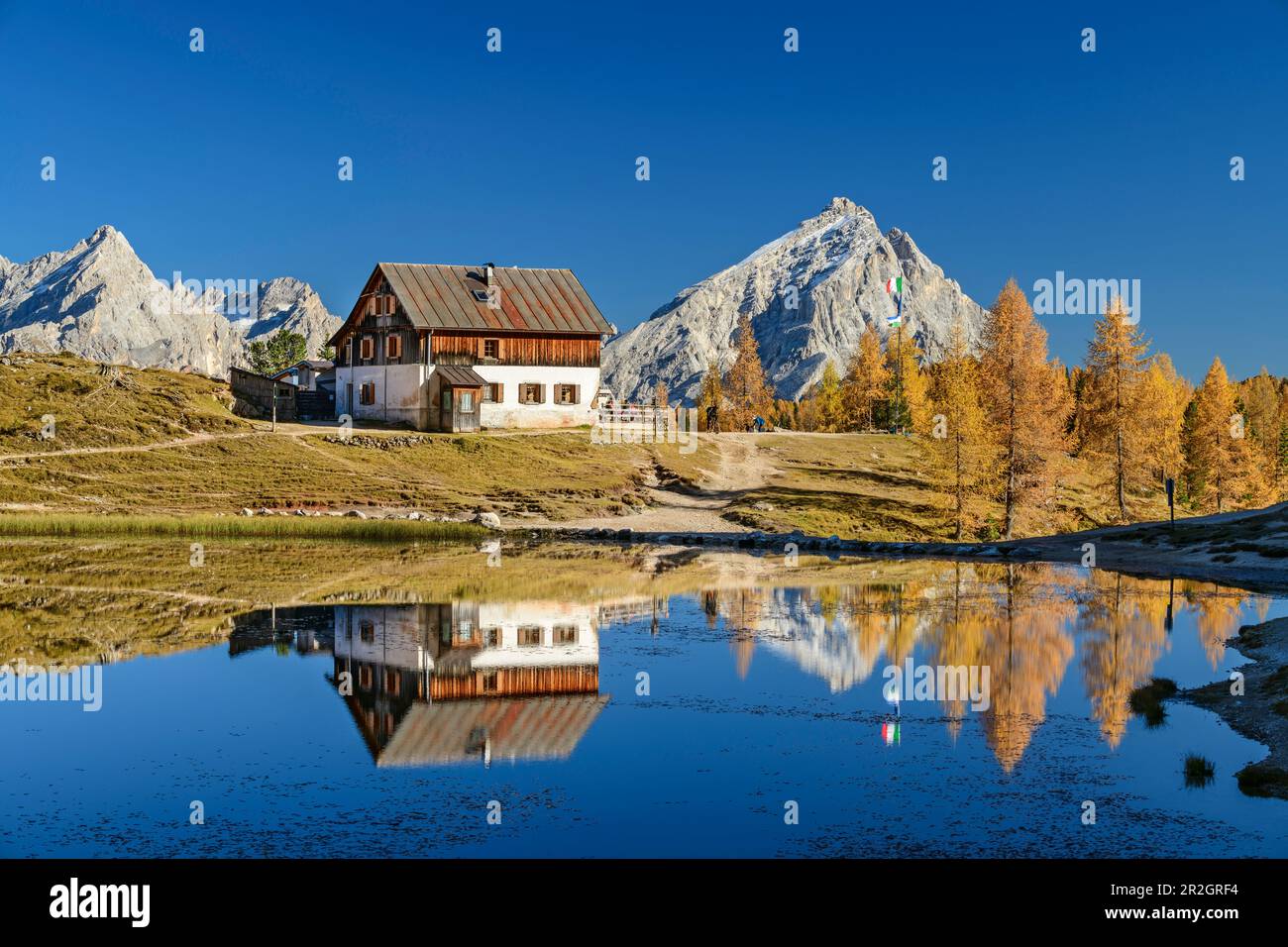 Mountain lake Lago Federa with Rifugio Croda da Lago, autumnal colored ...