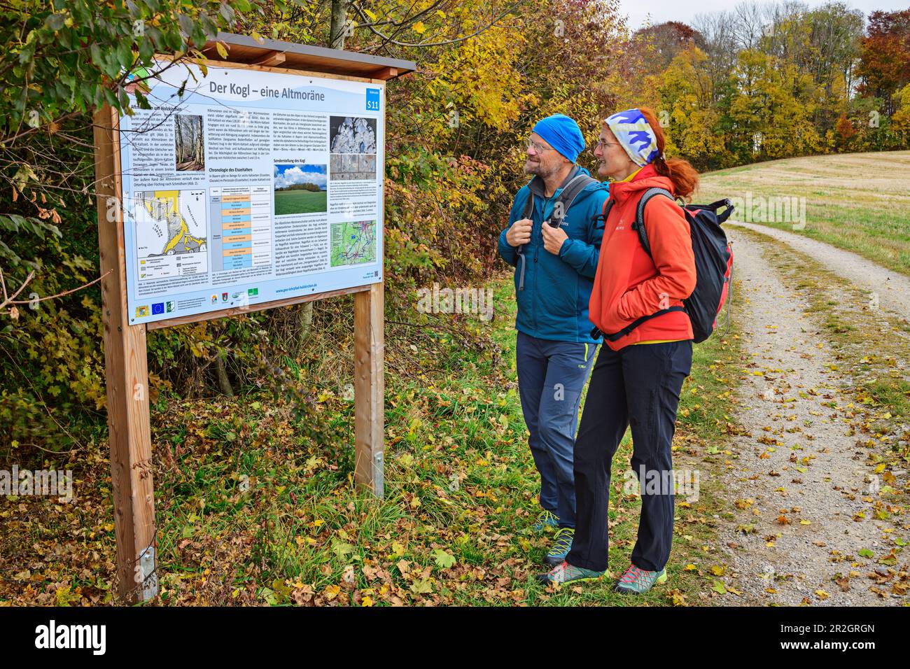 Man and woman hiking reading information board on the Holzkirchen ...
