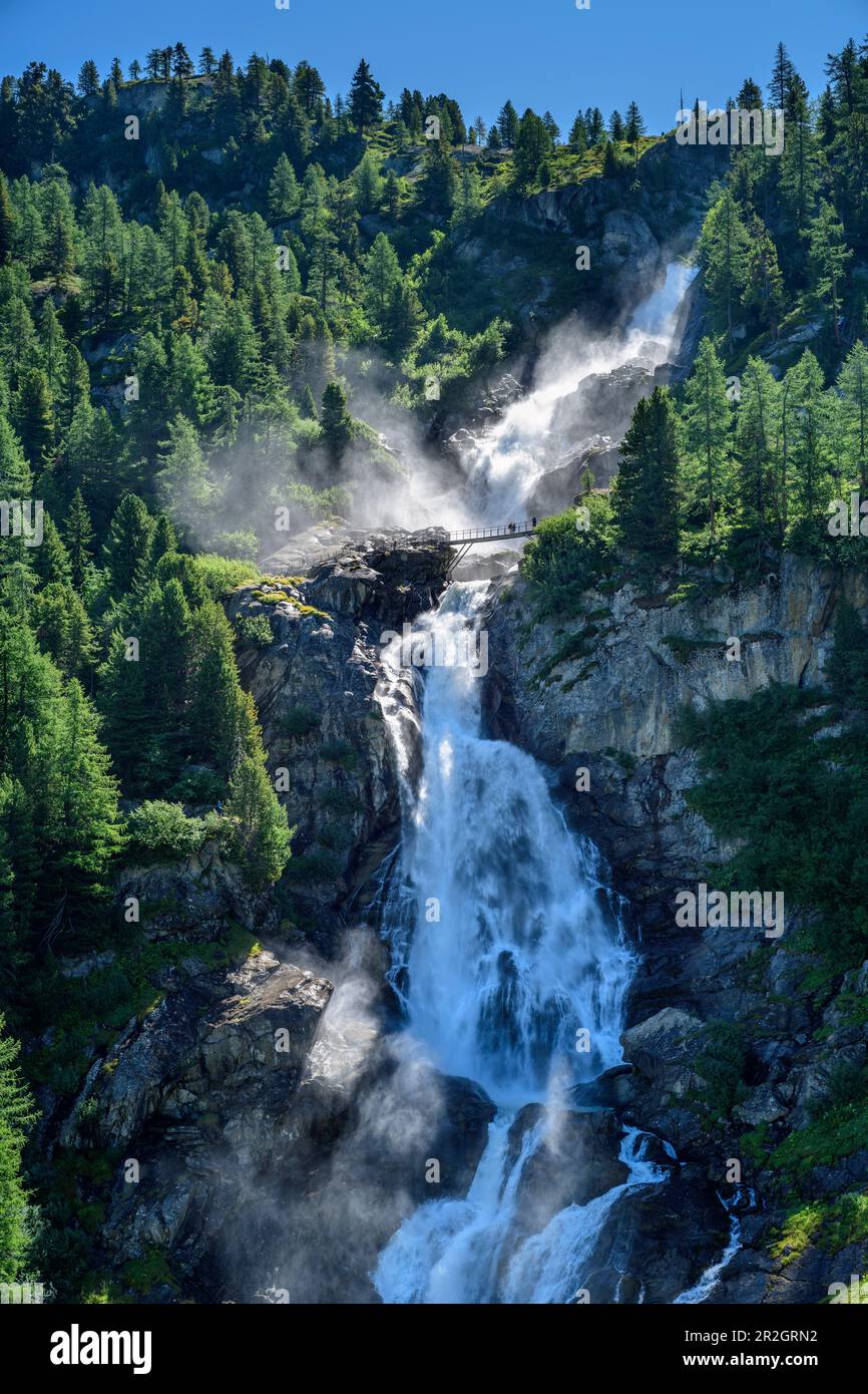 People stand on bridge in front of Rutor Waterfalls, Rutor Falls, Rutor ...