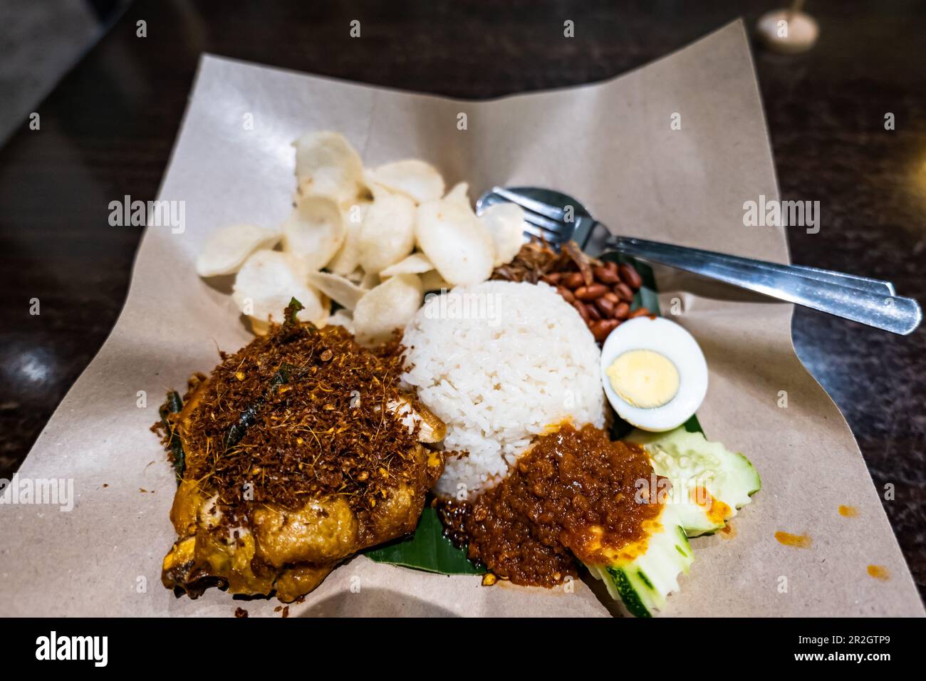 Nasi Lemak in street restaurant, a famous dish in Malaysia, Brunei and ...