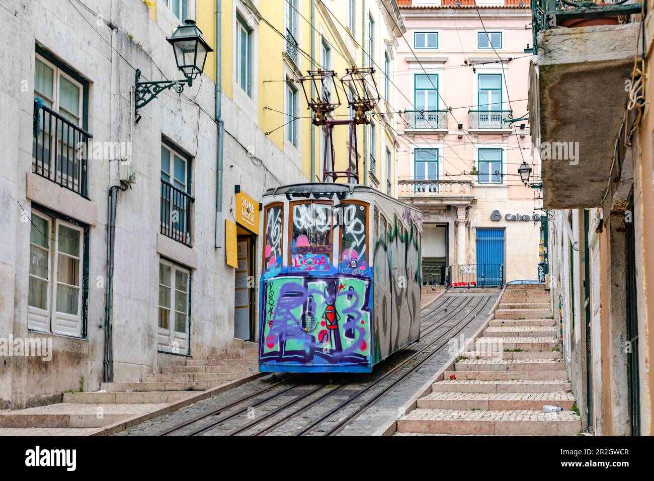 The Elevador da Bica funicular runs through the old town of Lisbon ...