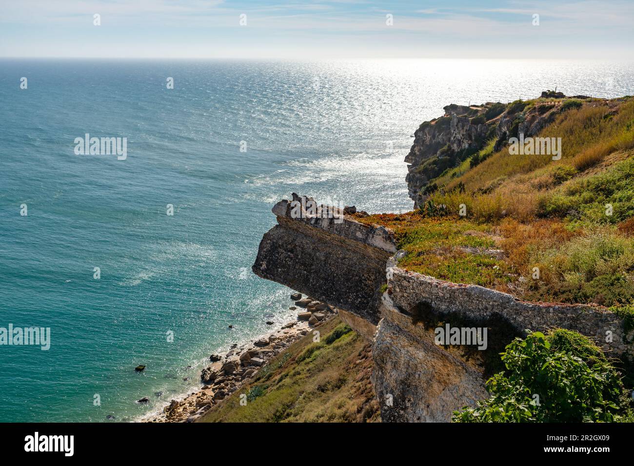 Rocky outcrop on the cliffs of the tourist town of Nazare on the ...