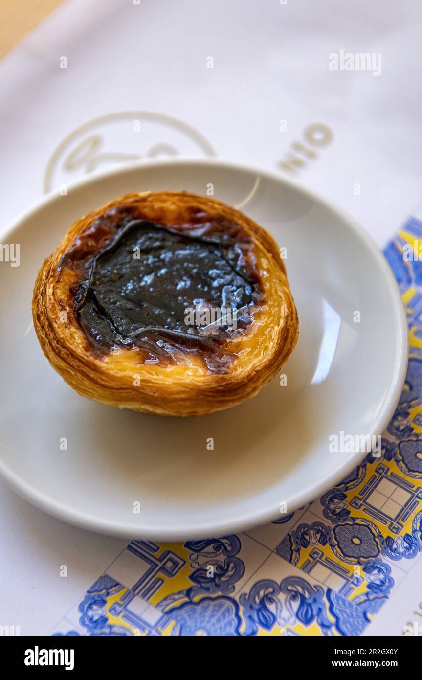 The making of Pasteis de Nata, Portuguese egg custard tarts Stock Photo ...