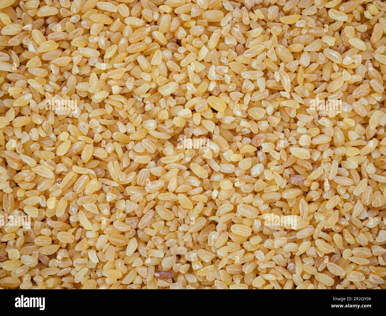 Raw bulgur wheat grain texture as background. Healthy, dietary, vegan ...