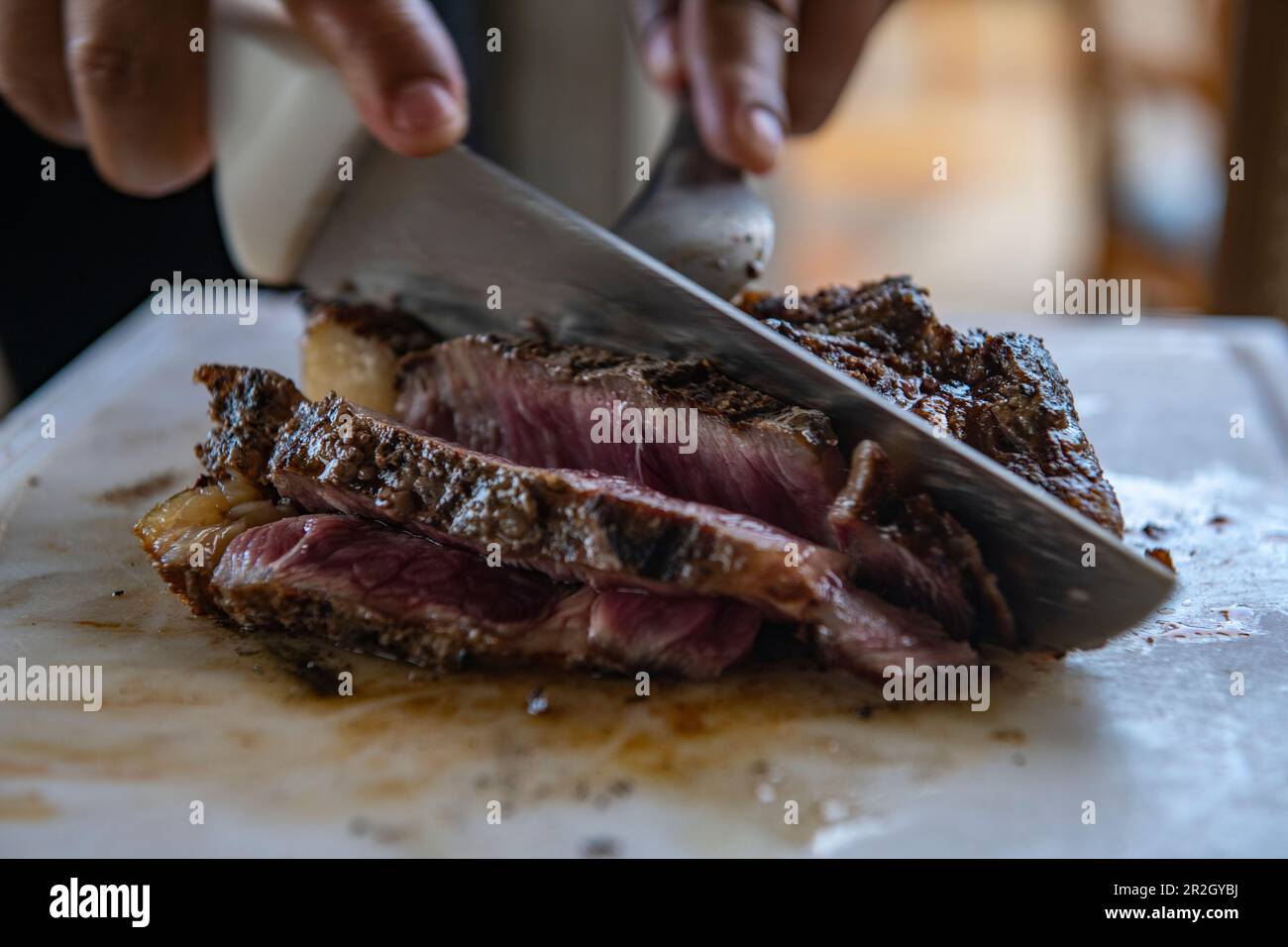Tender meat is sliced for diners at an Argentinian steakhouse in Rio de ...