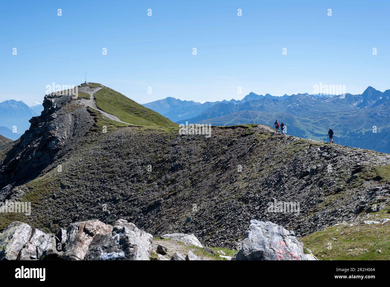 Hikers on the E5 European long-distance hiking trail, crossing the Alps ...