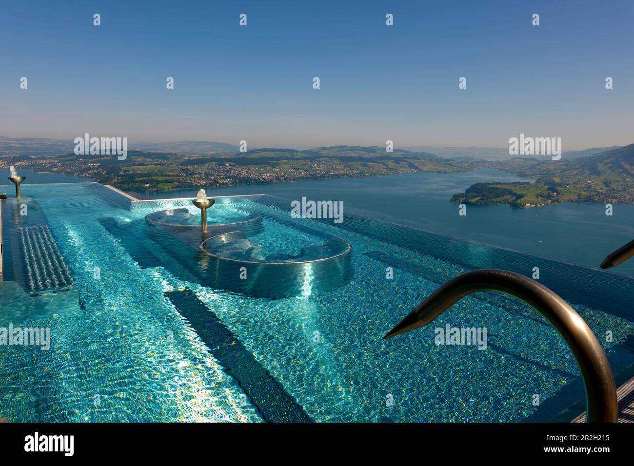 Infinity Swimming pool and View over Mountain and Lake and City of ...