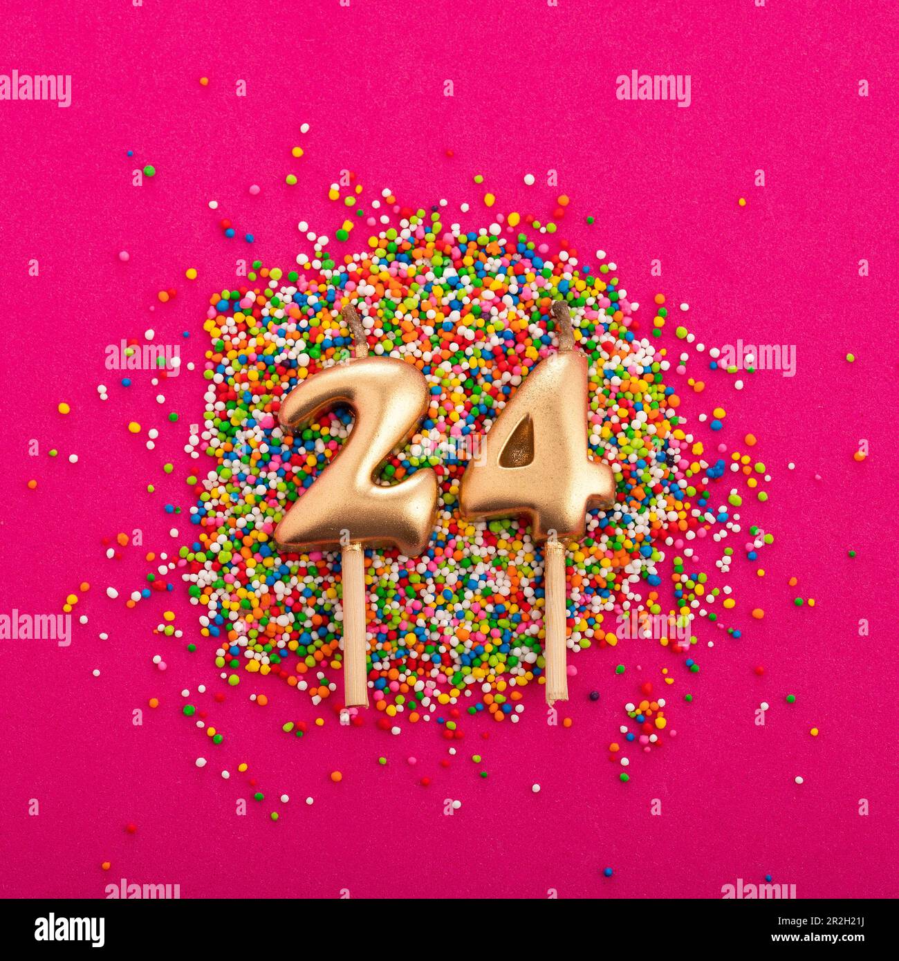 Candle number 24 - Birthday or anniversary on rhodamine red background ...