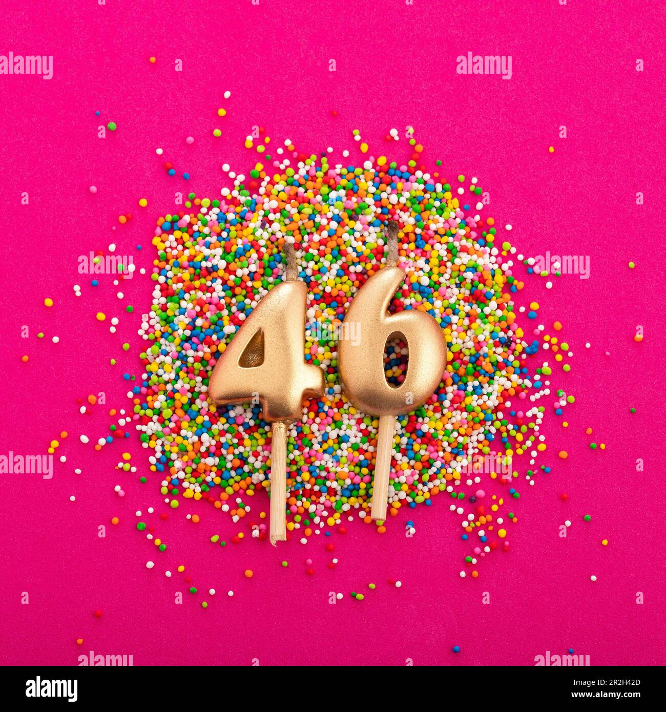 Candle number 46 - Birthday or anniversary on rhodamine red background ...