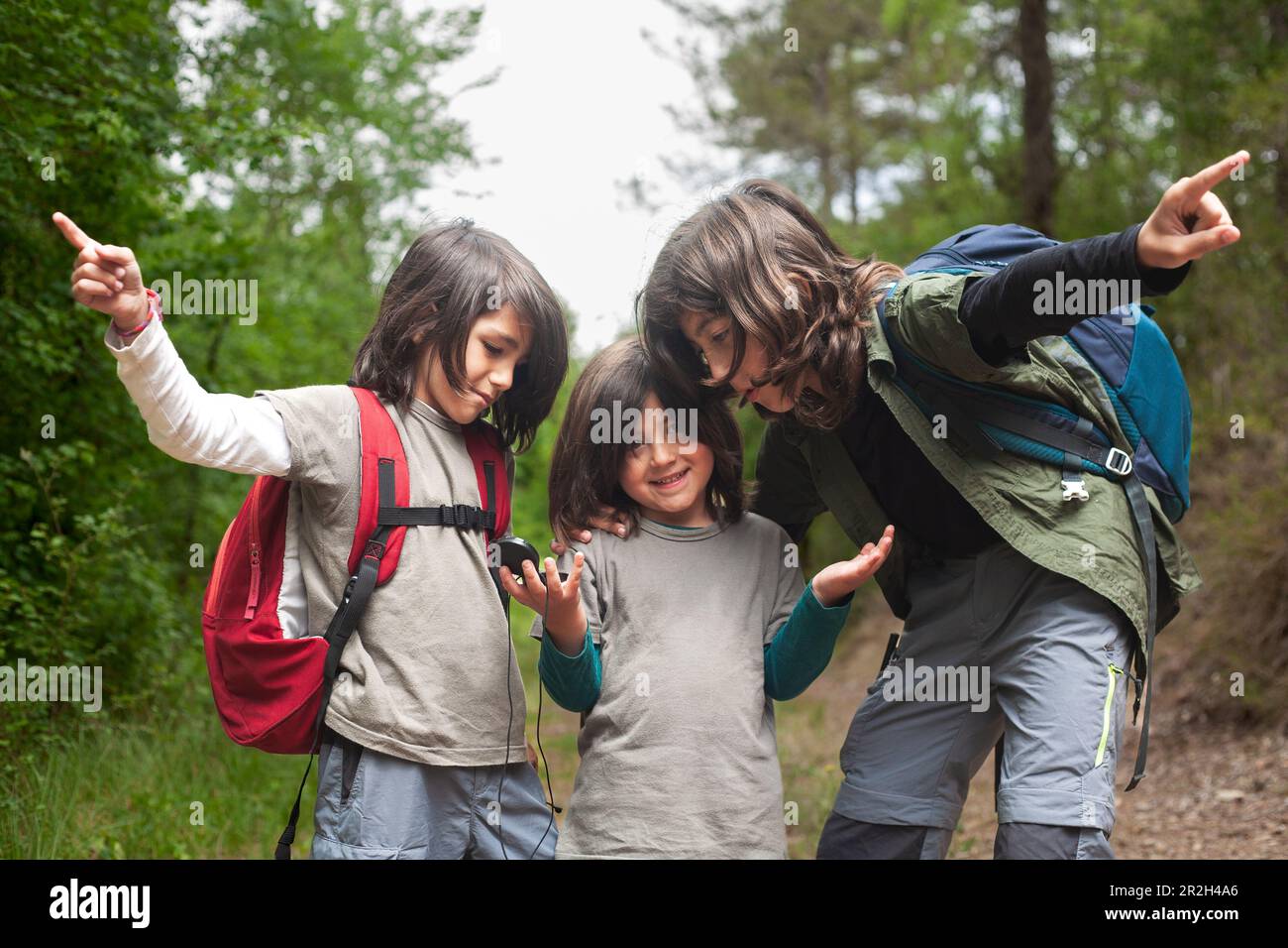 In this intriguing image, three siblings are consulting a compass. The ...