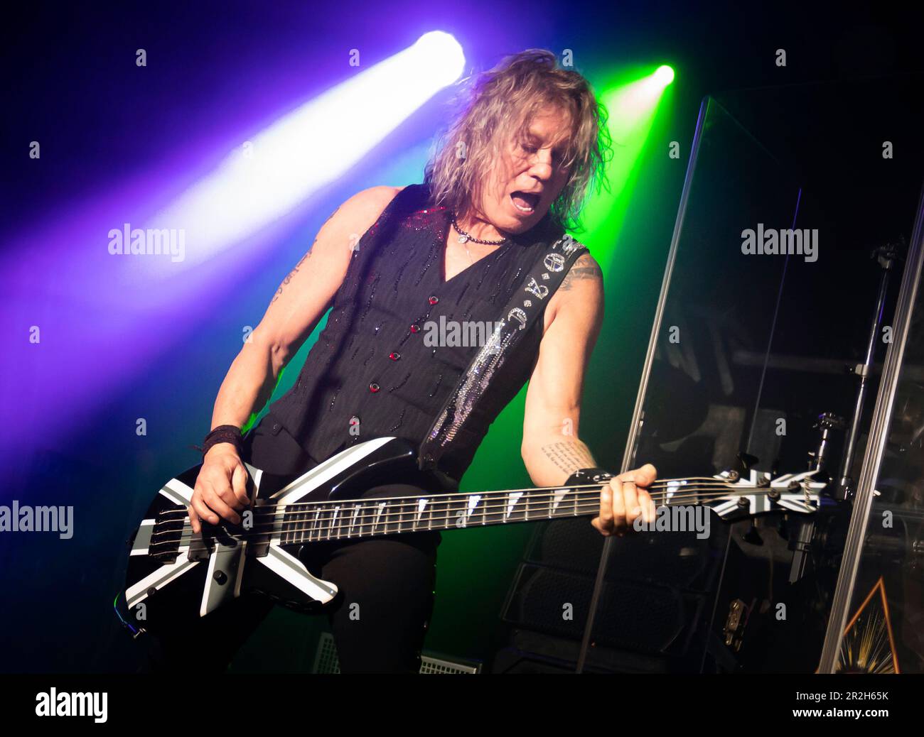 Bassist Rick Savage performs with Def Leppard on stage during their ...