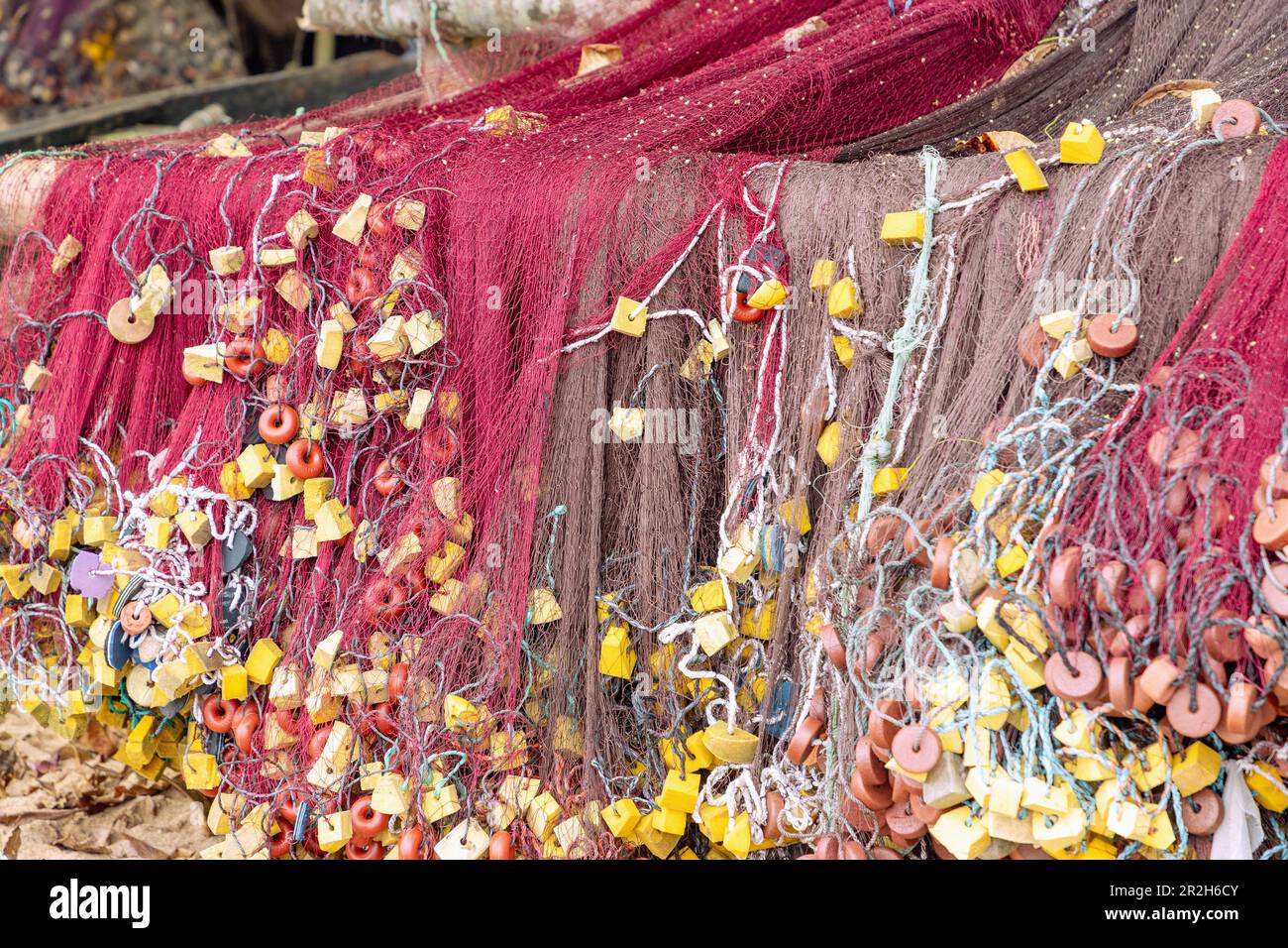 Fishing nets hung out to dry with colorful floats at Praia das Burras ...