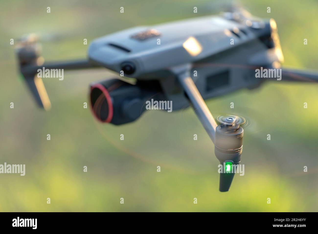 Drone aircraft with blurred fast rotating propellers and video camera ...