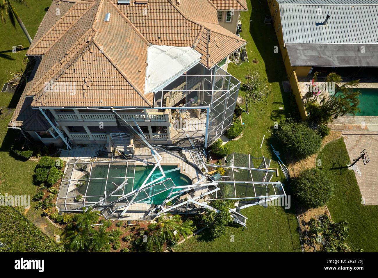 Hurricane Ian destroyed swimming pool lanai enclosure on house yard in ...