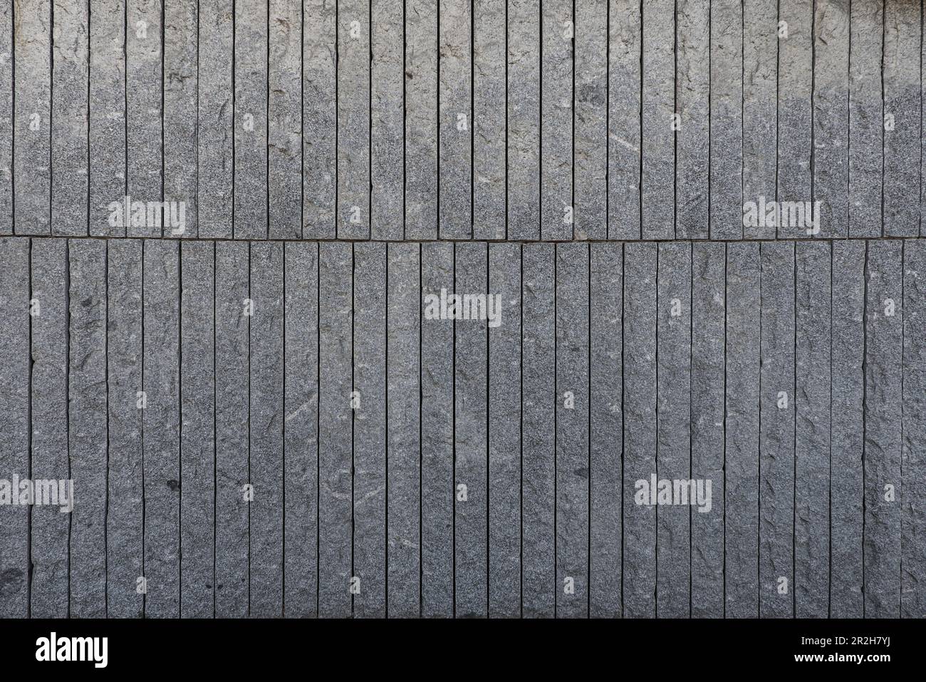 A large wall of raw gray granite strips. Vector stone texture background Stock Photo - Alamy