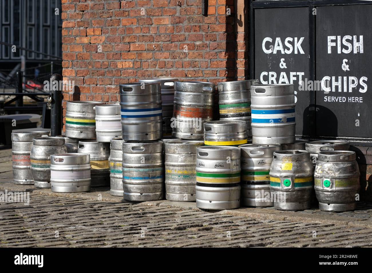 Empty beer kegs waiting collection Stock Photo - Alamy