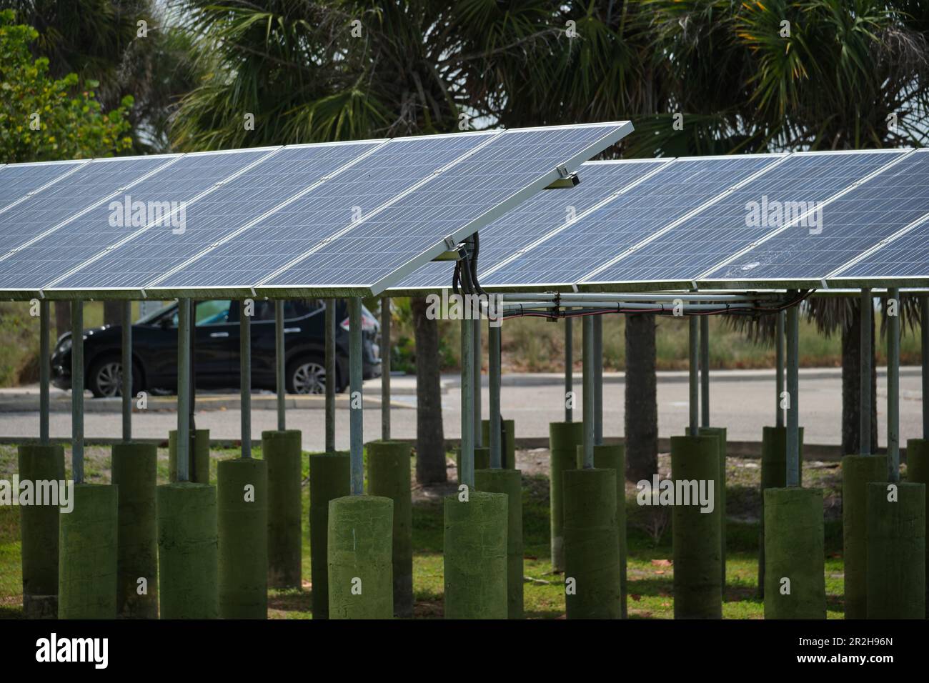 Solar panels installed on stand frame near parking lot for effective ...