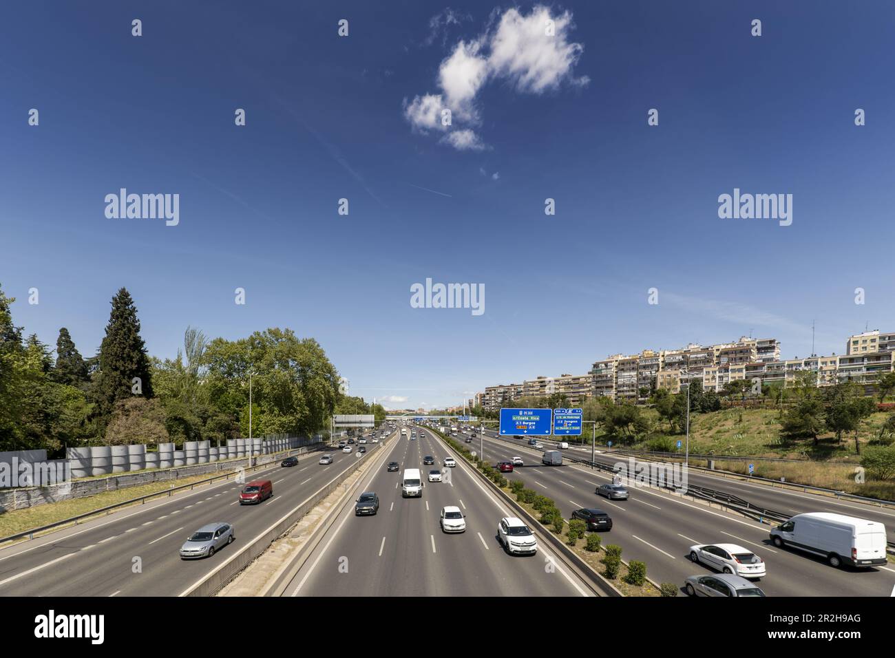 Road traffic in the lanes of the highway in the ring road of Madrid m ...