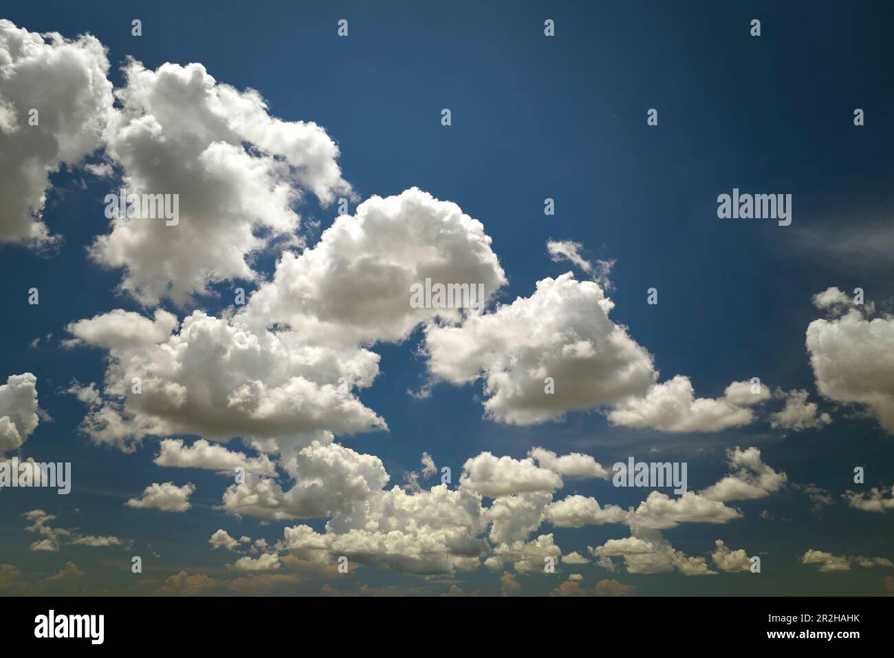 White puffy cumulus clouds on summer blue sky Stock Photo - Alamy