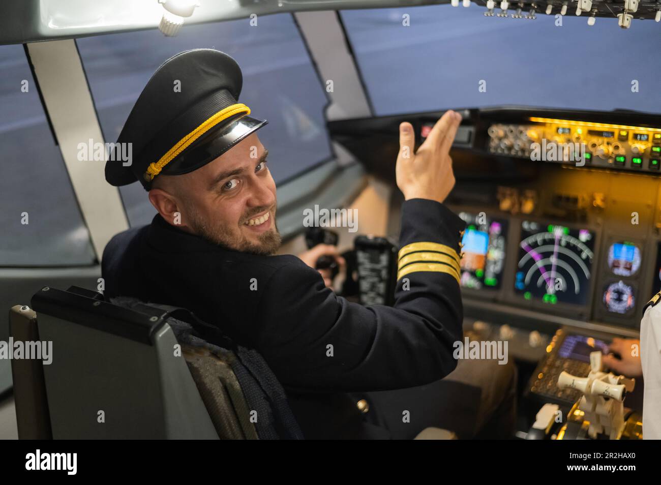 Caucasian bearded man smiling while driving a flight simulator. Pilot ...