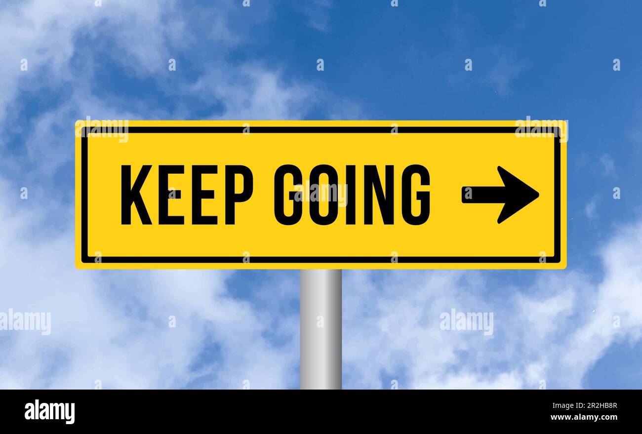 Keep going road sign on sky background Stock Photo - Alamy