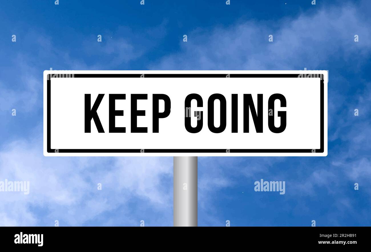 Keep going road sign on sky background Stock Photo - Alamy