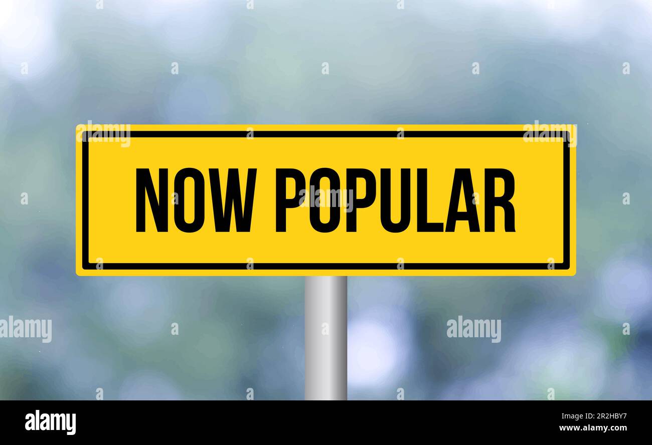 Now popular road sign on blur background Stock Photo - Alamy