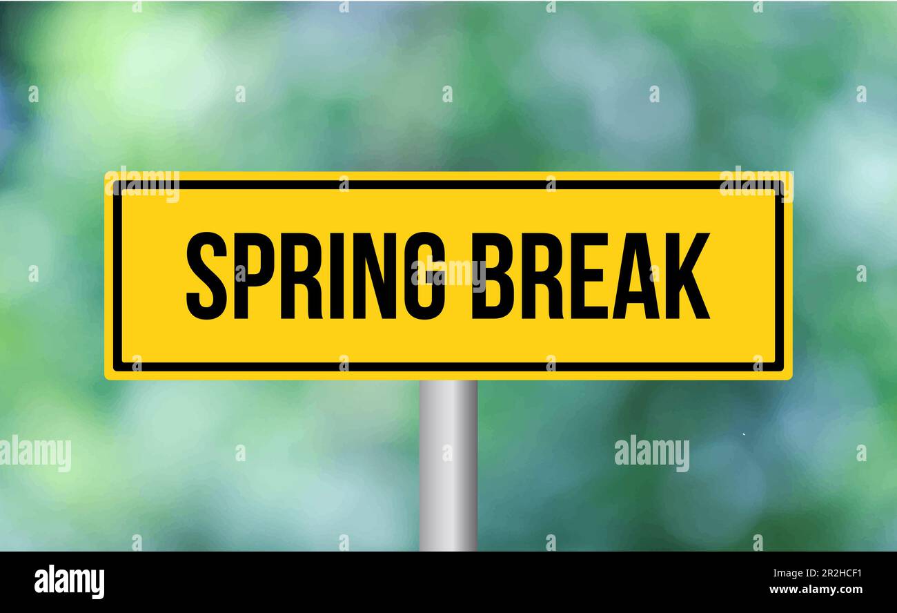 Spring break road sign on blur background Stock Photo - Alamy