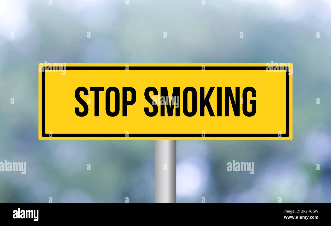 Stop smoking road sign on blur background Stock Photo - Alamy