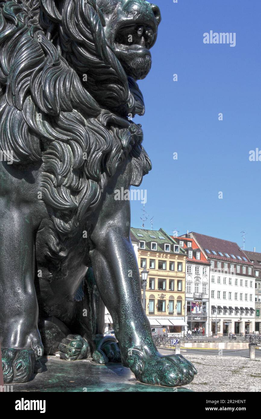 Lion at the base of the Max-Josef monument on Max-Josef-Platz with ...