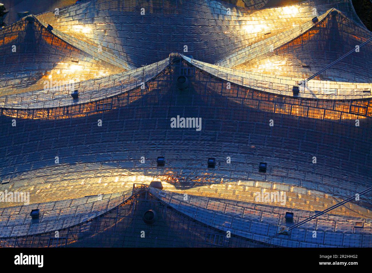 The setting sun reflects on the roof of the Olympic Stadium, Munich ...