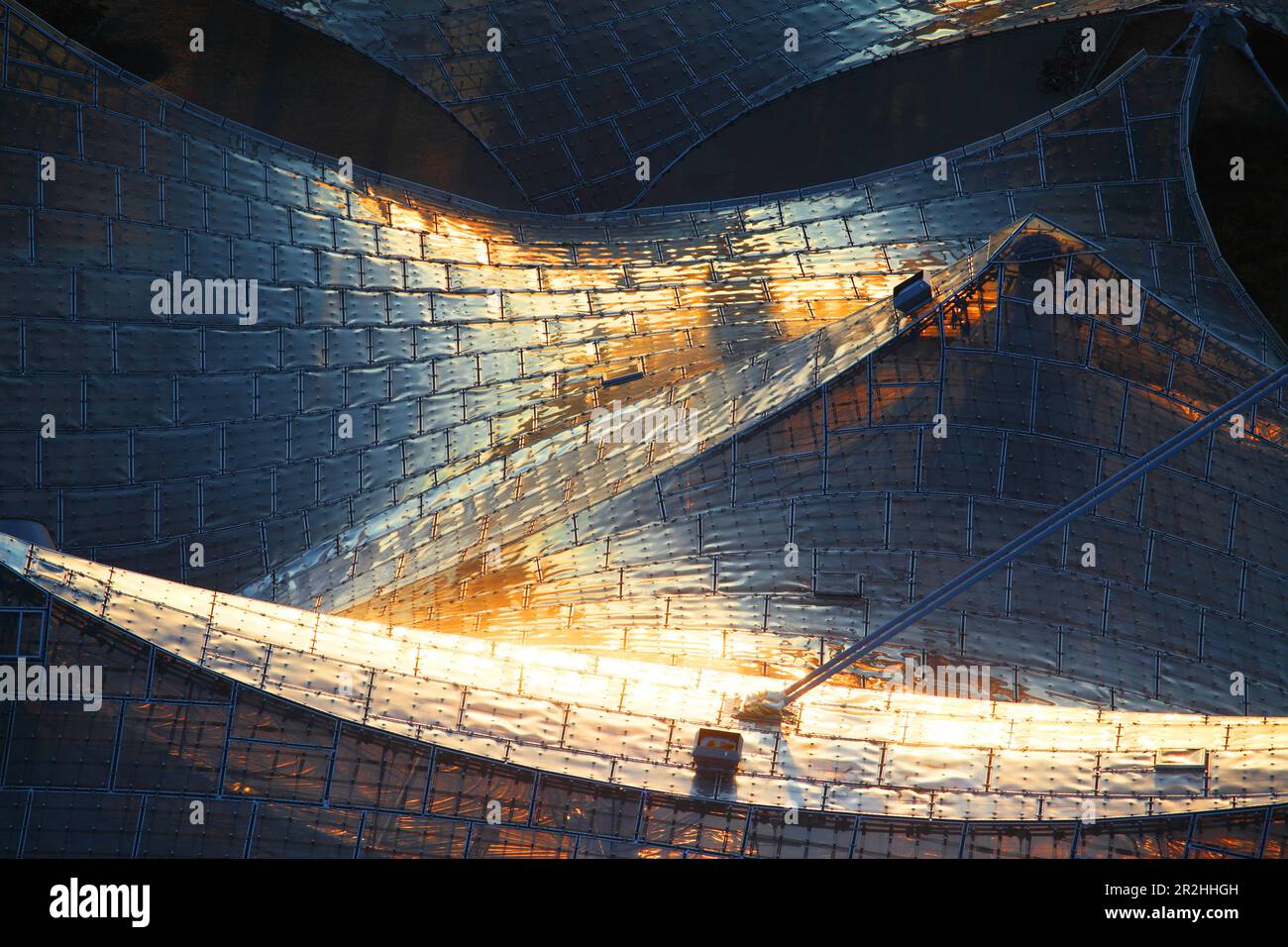 The setting sun reflects on the roof of the Olympic Stadium, Munich ...