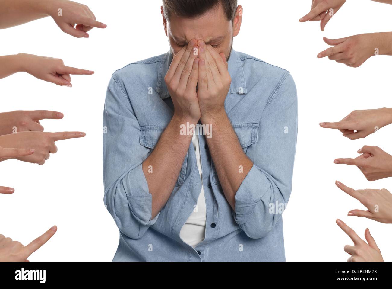 People bullying upset man on white background Stock Photo - Alamy