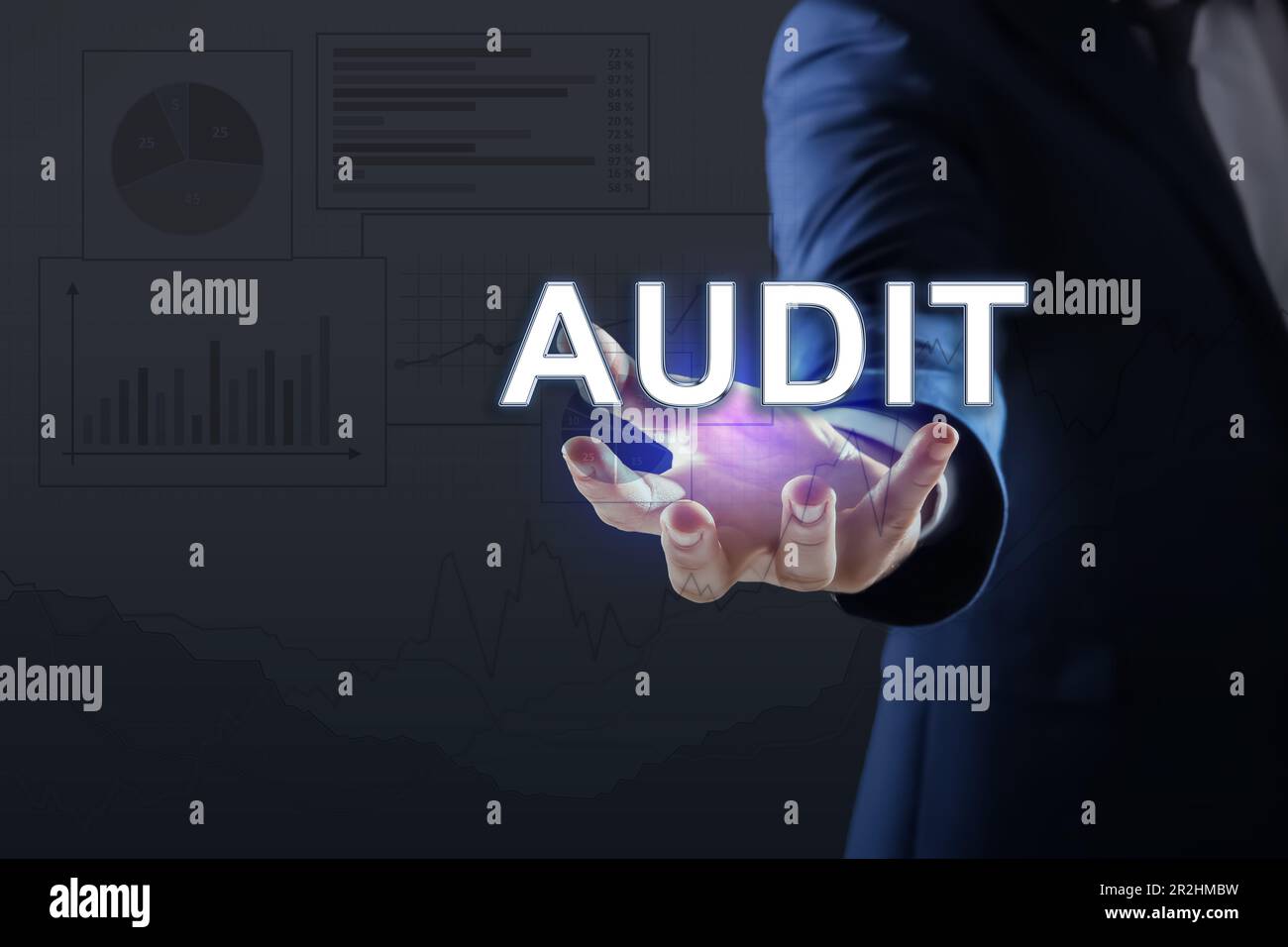 Audit concept. Businessman holding digital word in hand on dark ...