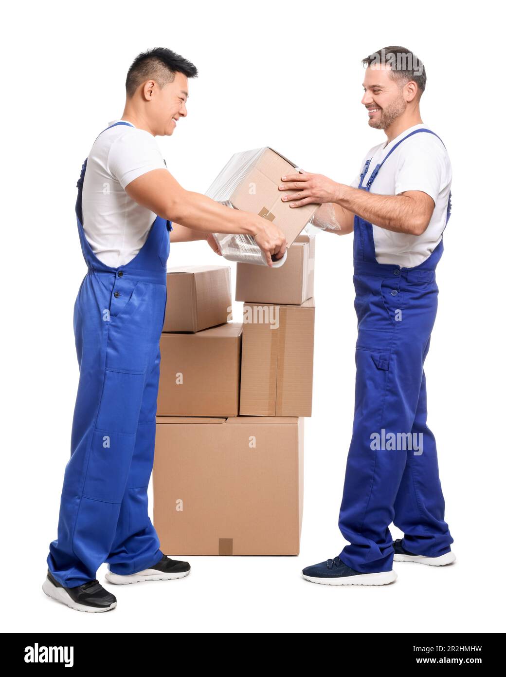 Workers wrapping box in stretch film on white background Stock Photo ...
