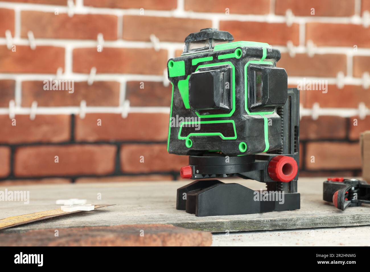 Modern cross line laser level on floor indoors, space for tex. Tiles ...