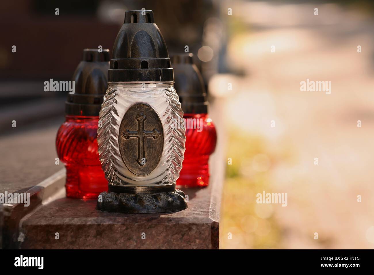 Grave lanterns on granite surface in cemetery, space for text Stock Photo - Alamy