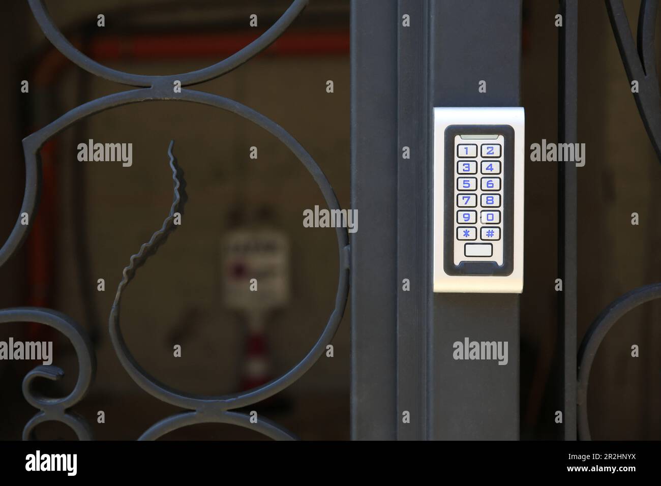 Modern intercom system on black metal gates, space for text. House ...