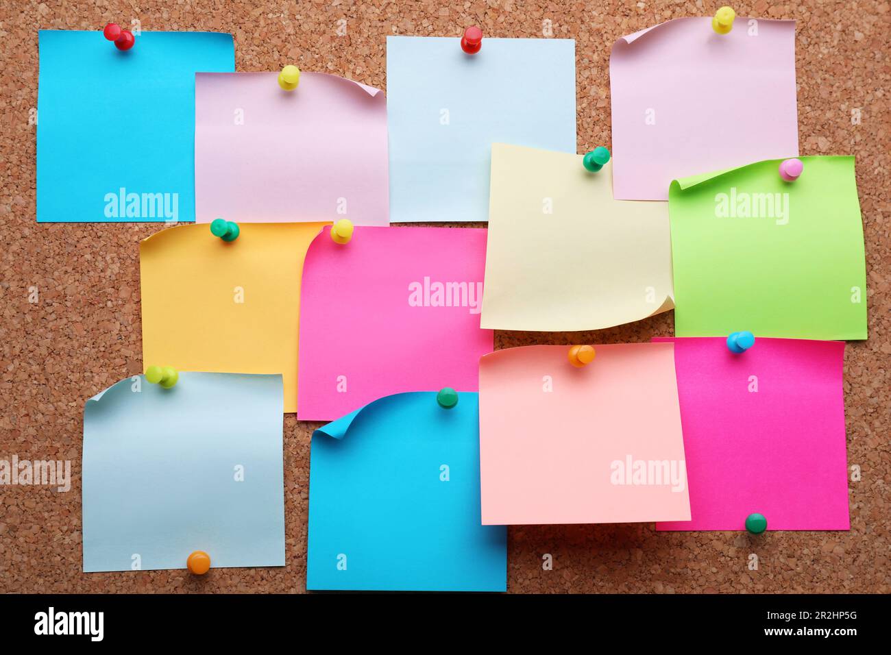 Many empty colorful notes pinned to cork board Stock Photo - Alamy