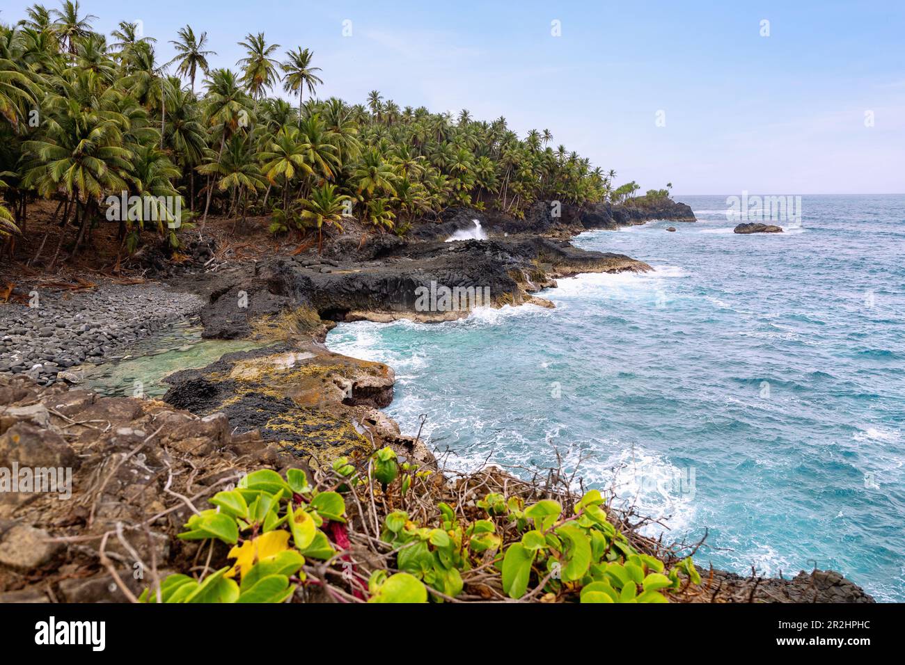 Basalt coast at Praia Piscina in the south of the island of São Tomé in ...