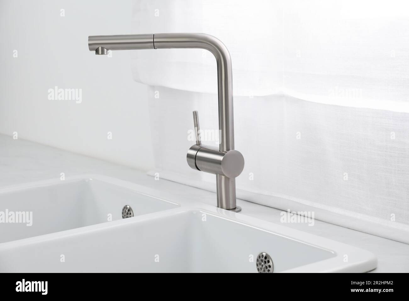 Modern sink and water tap near window in kitchen. Interior design Stock ...