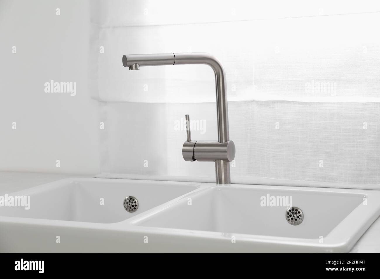 Modern sink and water tap near window in kitchen. Interior design Stock ...