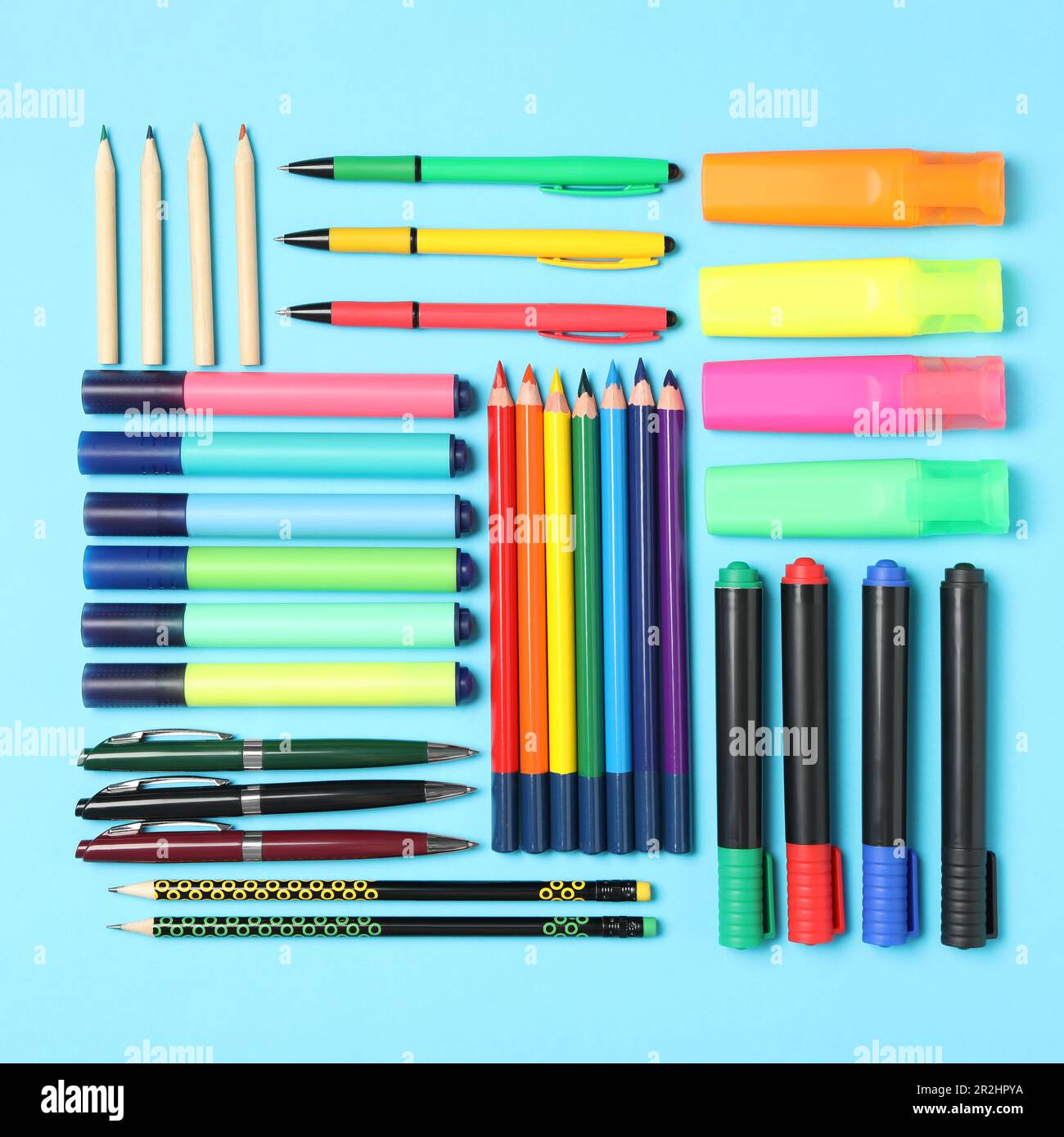 Different stationery on light blue background, flat lay. Back to school ...